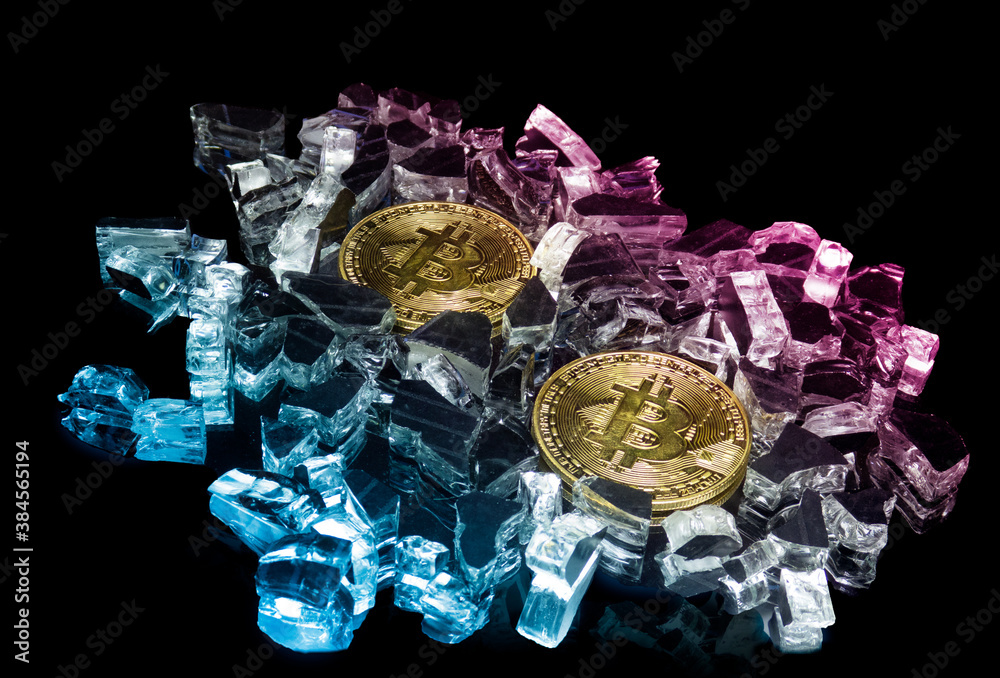 Two gold coins was placed in the dark background very colorful, which ...