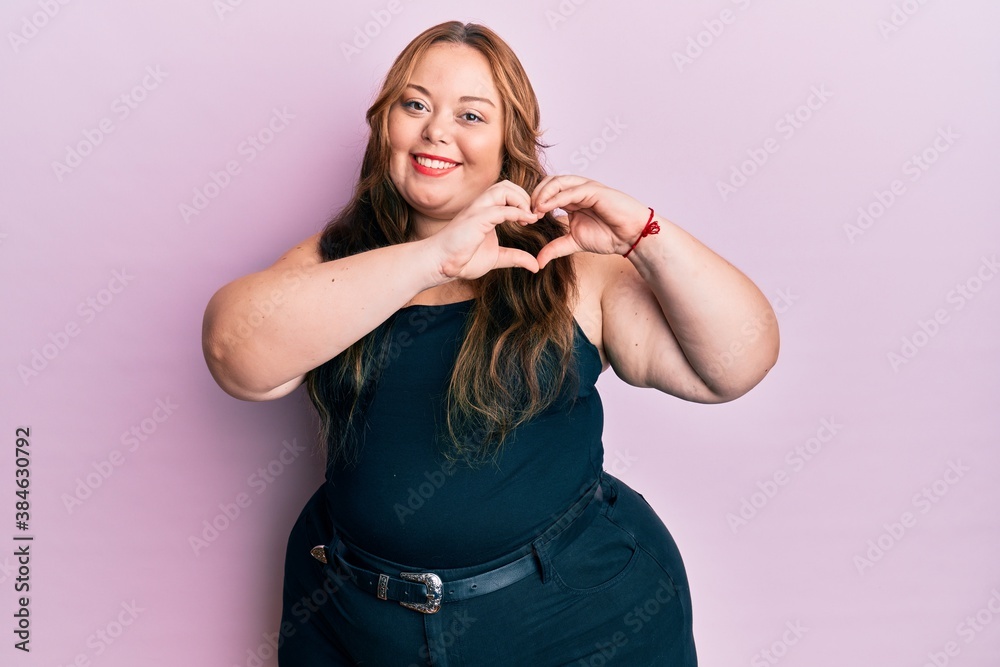 Plus size caucasian young woman wearing casual clothes over pink ...