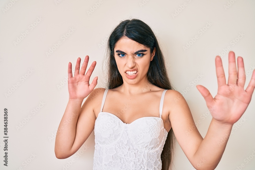 Brunette teenager girl posing elegant afraid and terrified with fear ...