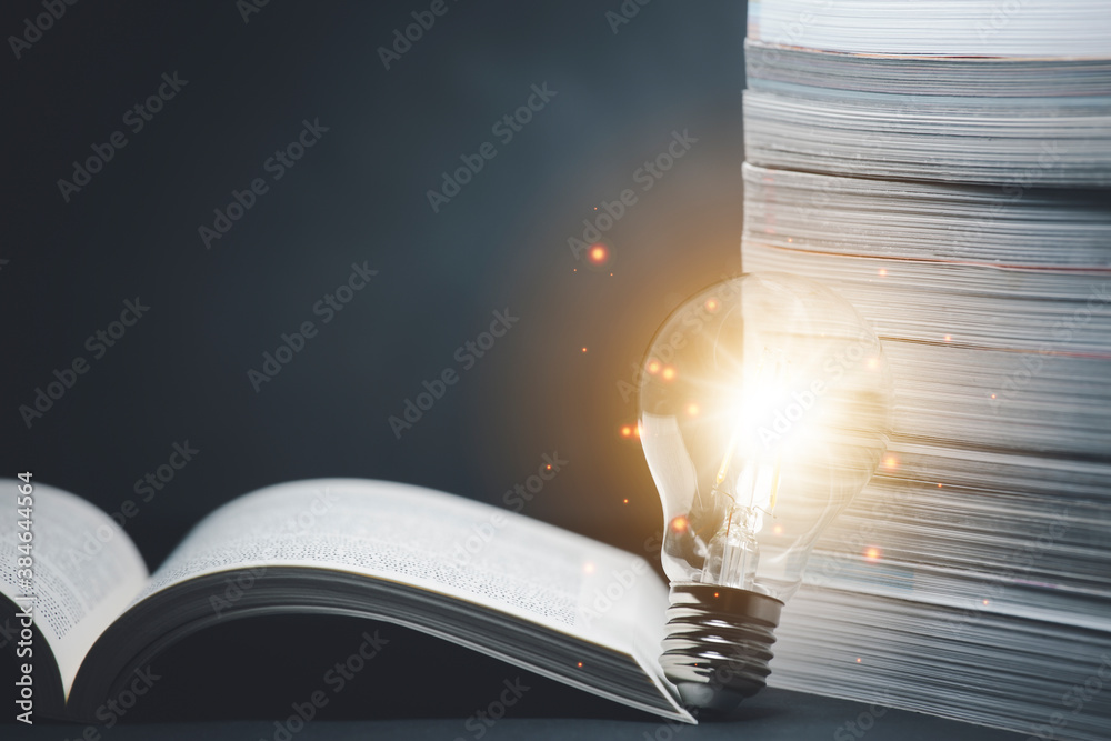 Light bulb and vintage book style vintage dark background,The idea of reading books, knowledge ...