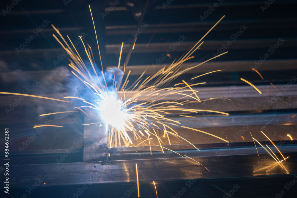 The welder is welding the parts of the iron door. The person working on ...