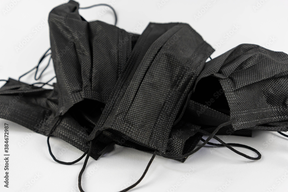 Used surgical masks thrown on the white floor. Plenty of Masks used for ...