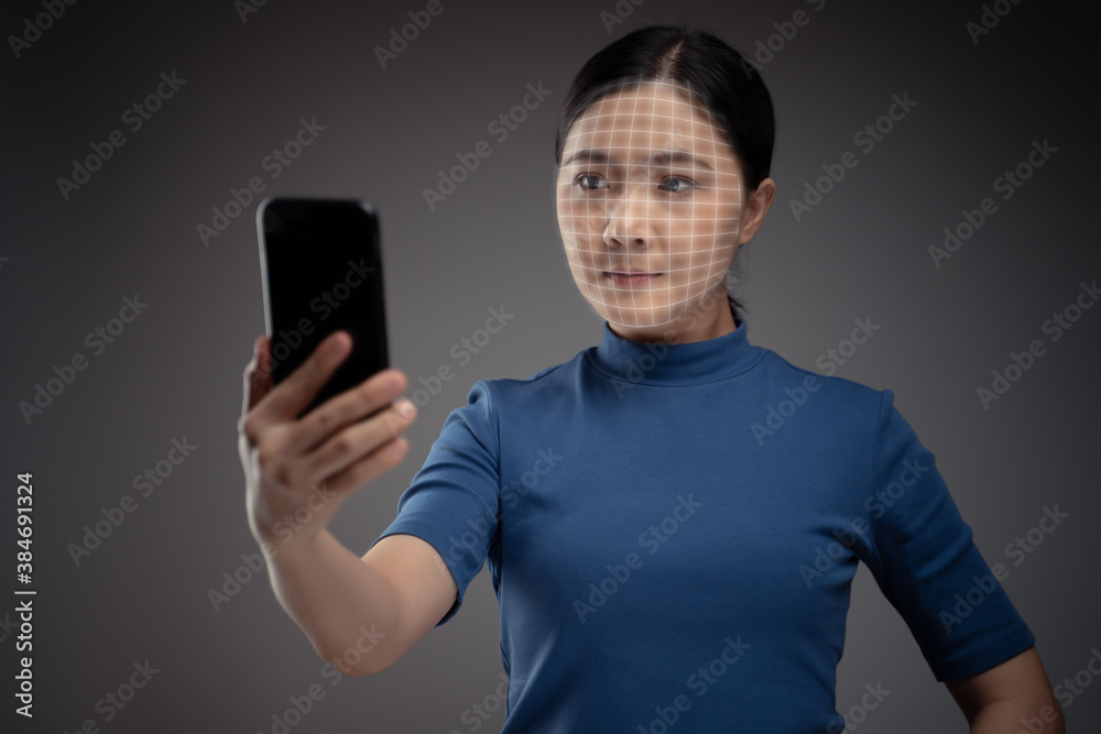 Asian woman scans face by smart phone using facial recognition system ...