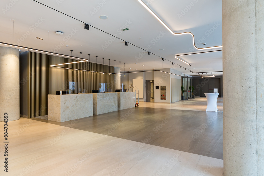 Interior of a hotel lobby with reception desks with transparent ...