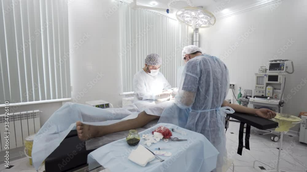 Process of surgery in the sterile operating room. Action. Two ...