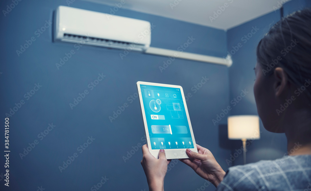 Smart home modern technology Asian girl sitting living room using ...