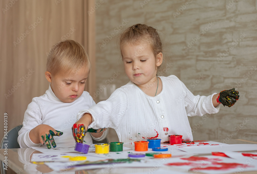 Little children paint with paints. The kids got their hands dirty in ...