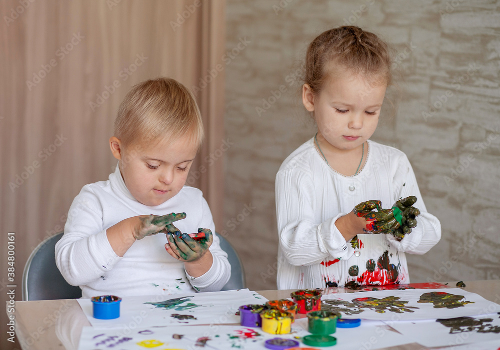 Little children paint with paints. The kids got their hands dirty in ...