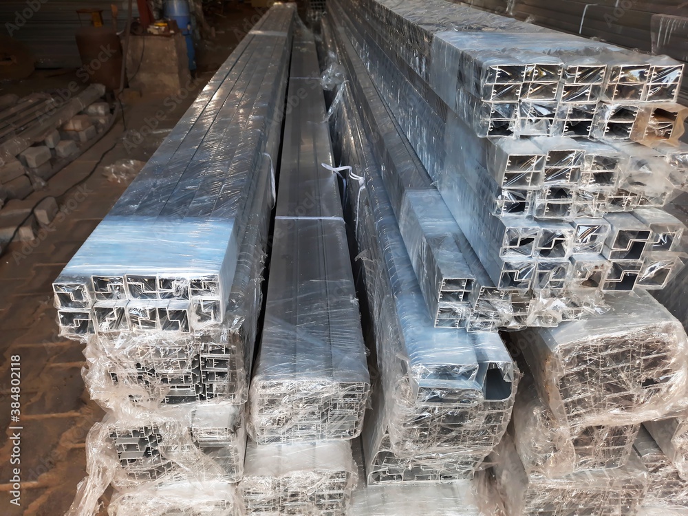 Anodized aluminium metal frames wrapped in polythene in a factory Stock ...