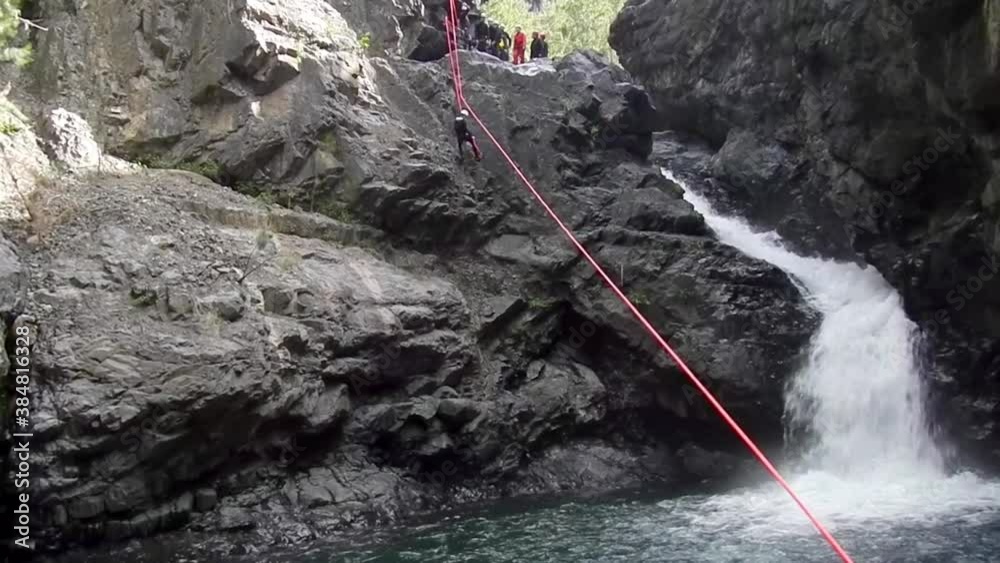 Going down a zip line in the Trou Blanc canyon, one of the most ...