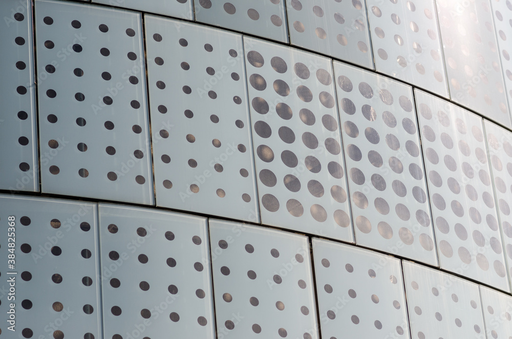 detail of a curved building, with wavy lines with the background sky ...
