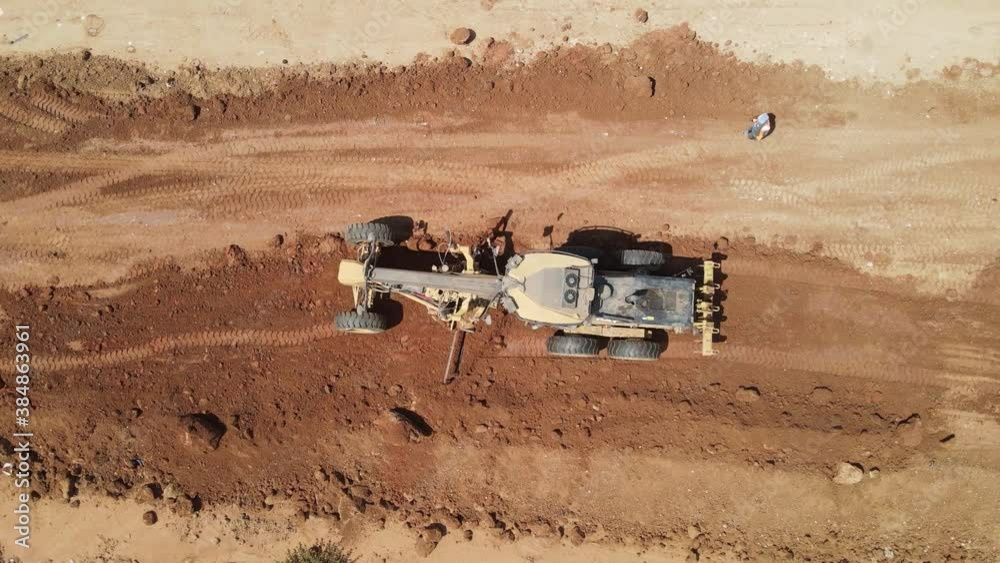 Aerial view of heavy machinery a road grader, motor grader, working in ...