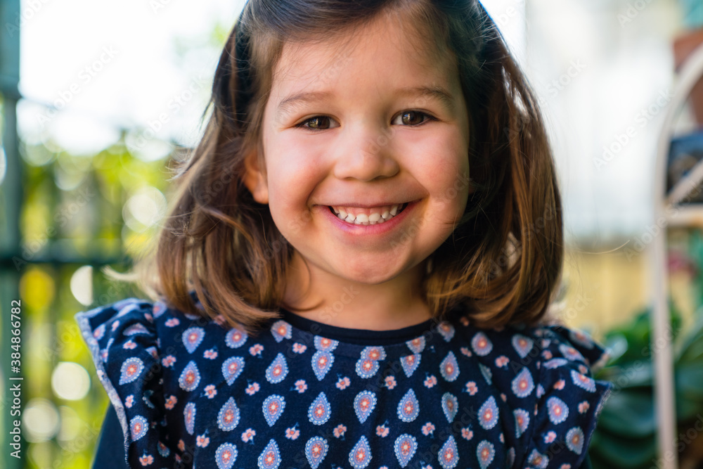 Cute happy preschool girl in garden Stock Photo | Adobe Stock