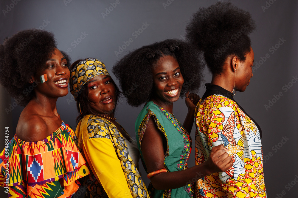 Four young beautiful African fashion models have fun and laughing in ...