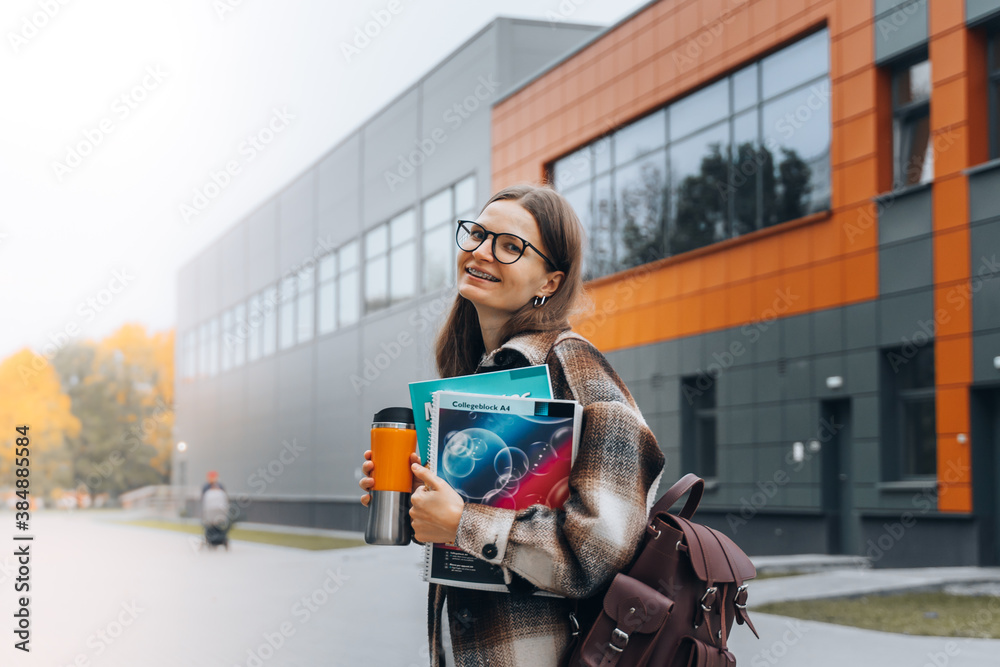 millennial caucasian female student in glasses and dental braces with ...