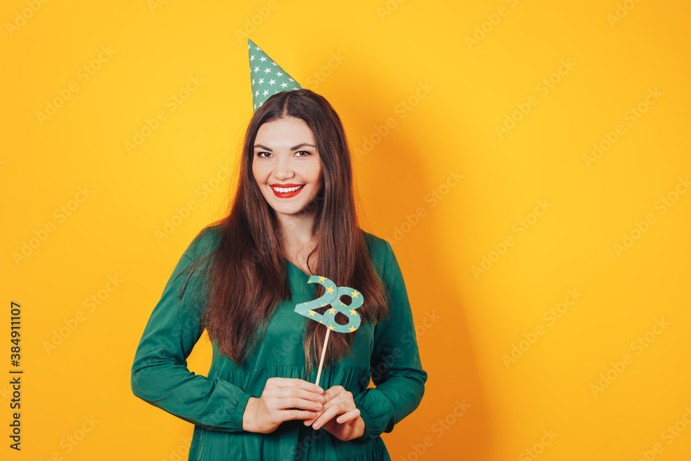 Beautiful Woman Celebrates Her Birthday On A Yellow Background In Green