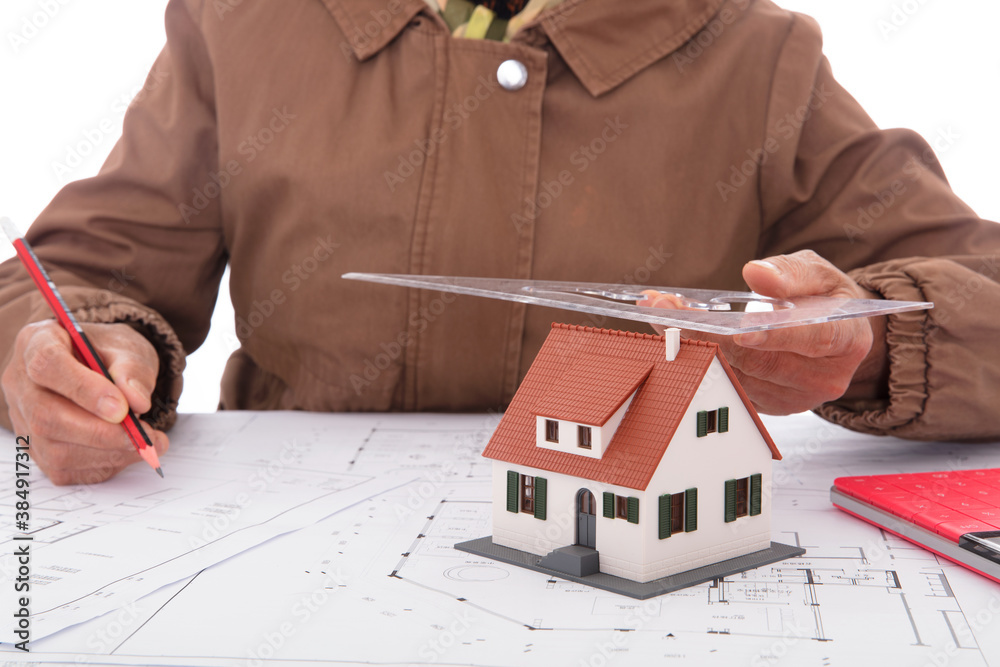 The architect used a ruler to measure the house model to analyze the ...