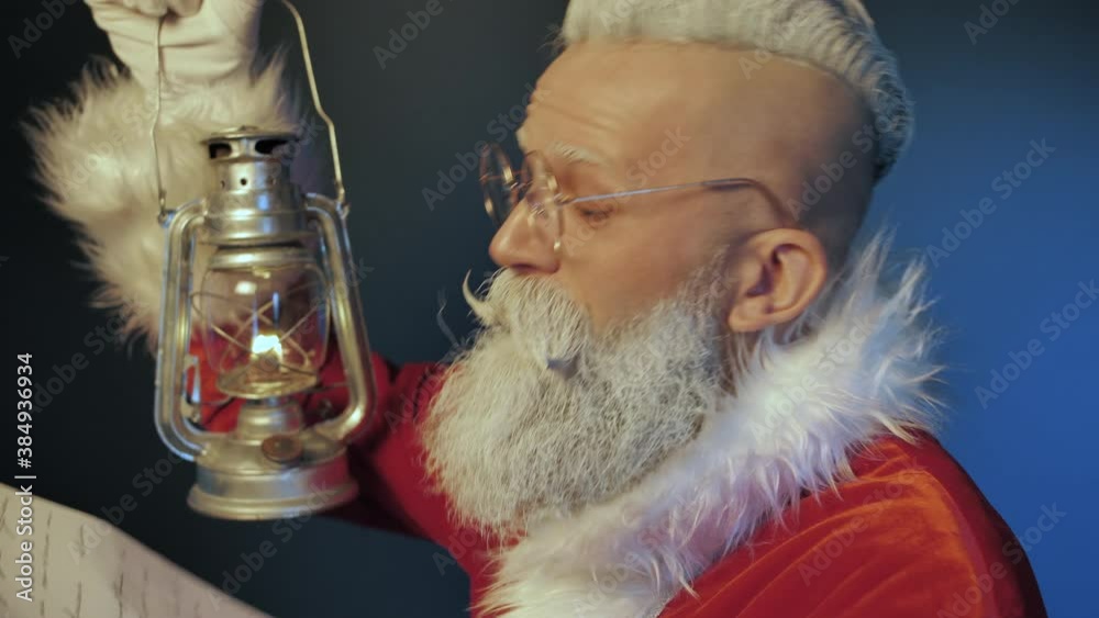 Funny Santa Claus reading magical wishes list from kids for preparing ...