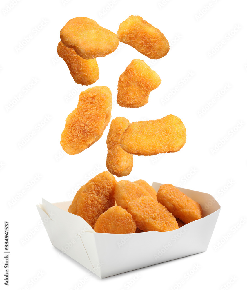 Fresh chicken nuggets falling into container on white background Stock ...
