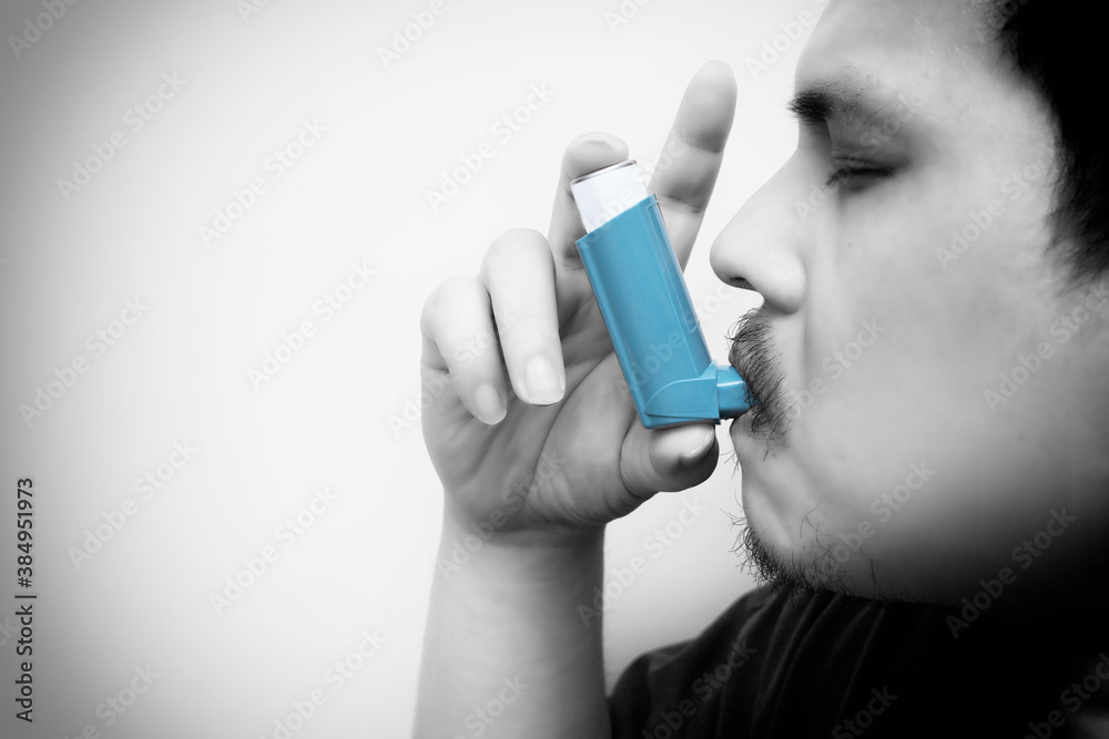 Asian fatty man using a pressurized cartridge inhaler extended pharynx ...