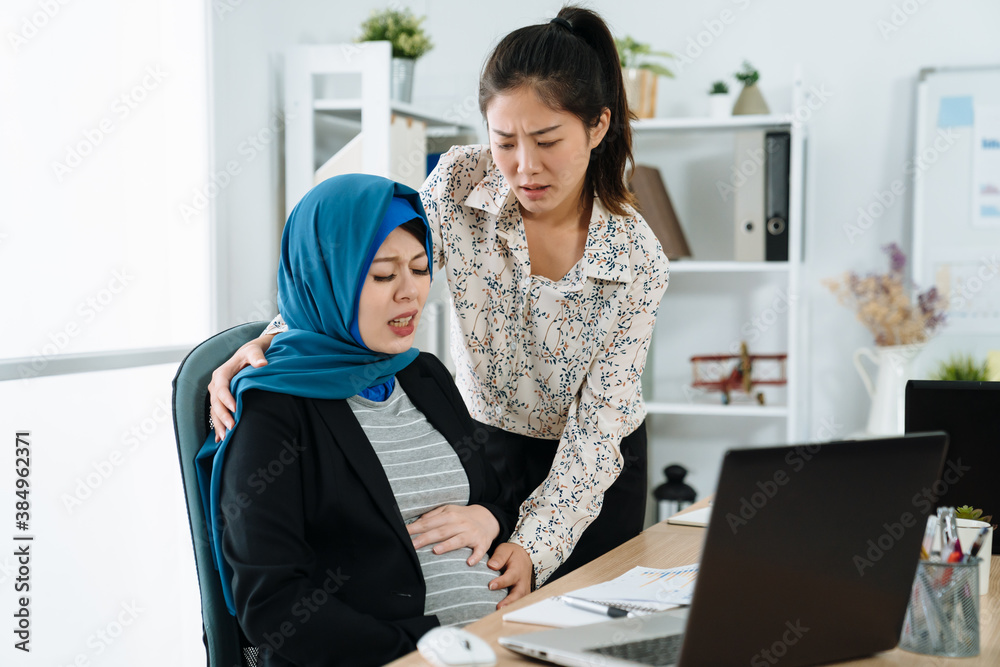 muslim pregnant woman is experiencing labor in office. painful young ...