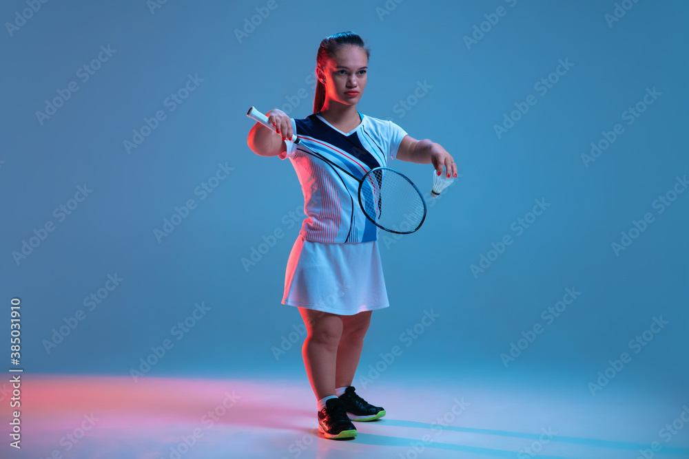 Leader. Beautiful dwarf woman practicing in badminton isolated on blue ...