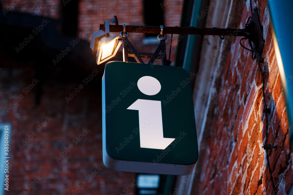 Information symbol on the ancient building. Tourist sign. Brick wall ...