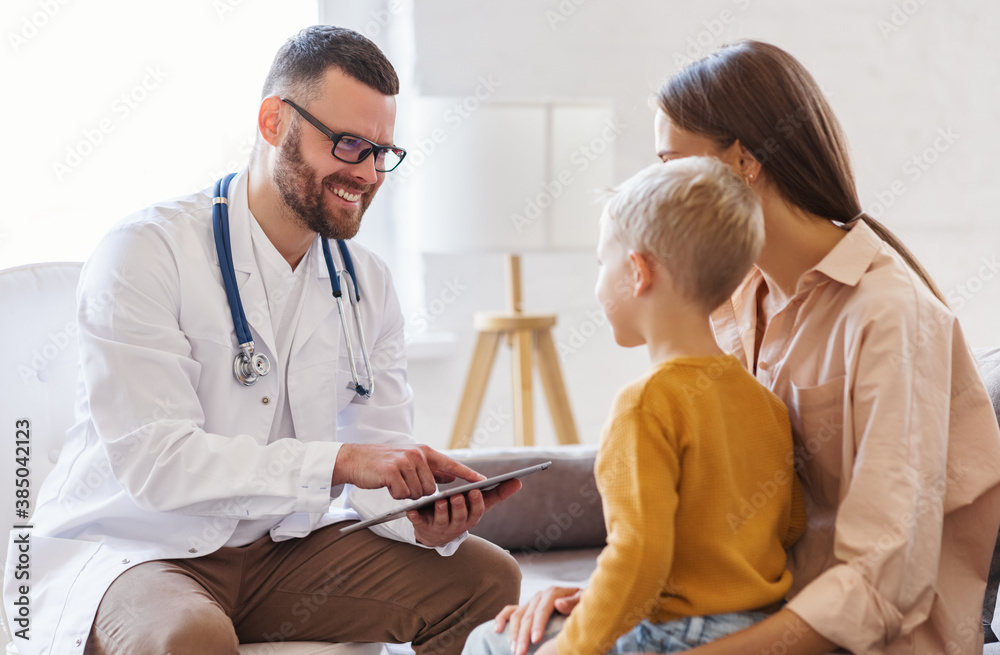 family doctor pediatrician conducts examination of child boy with his ...