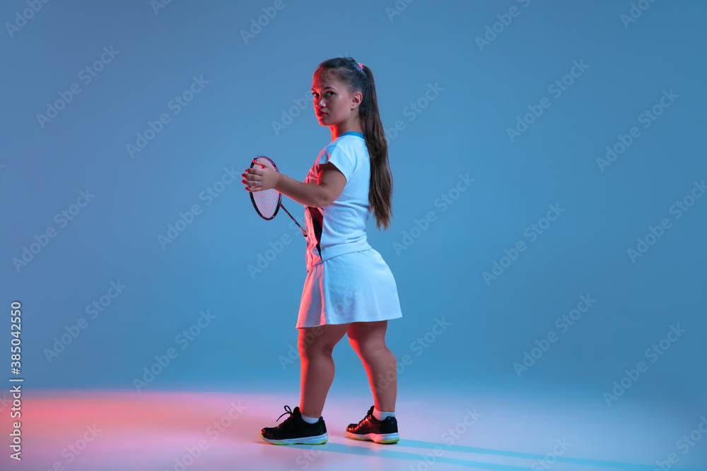 Dynamic Beautiful Dwarf Woman Practicing In Badminton Isolated On Blue