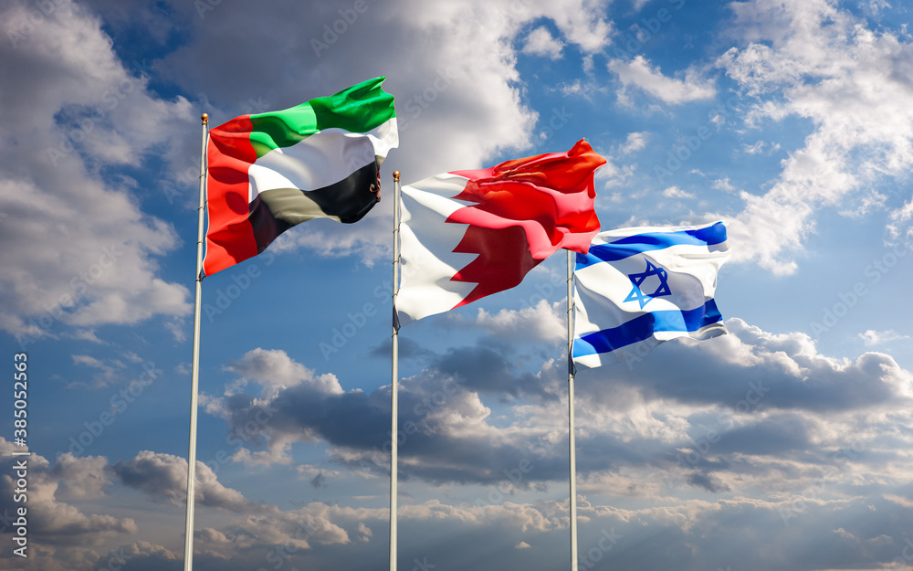Flags of Israel, UAE and Bahrain together against the sky background ...