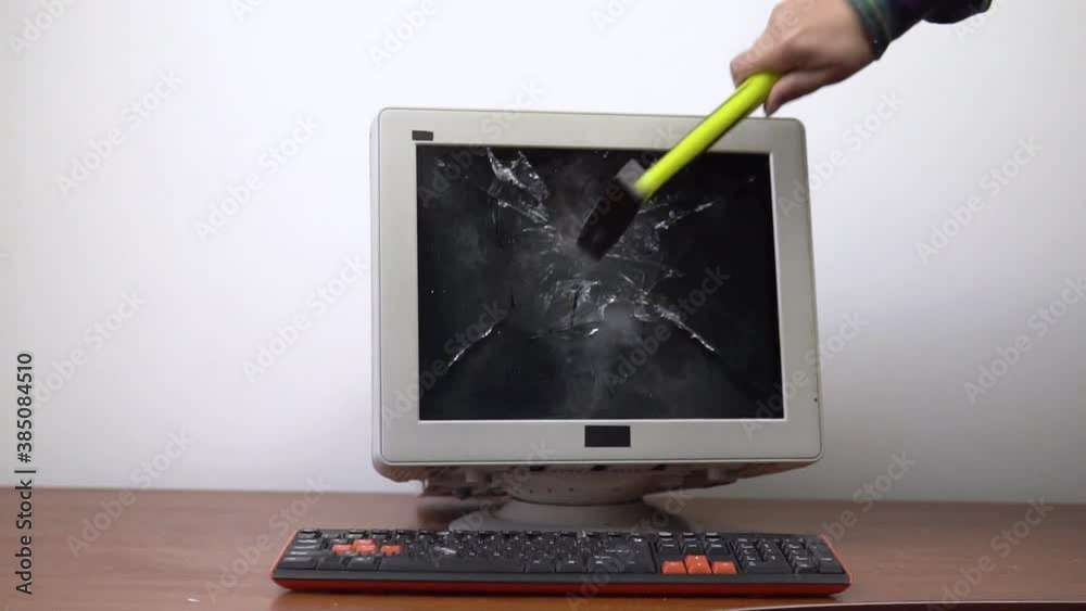 Video „An old monitor sitting on a table is smashed with a hammer. The ...