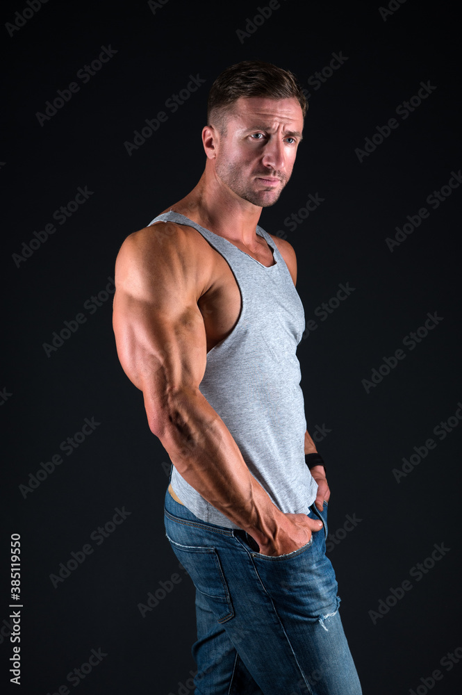 Fit athlete wear casual undershirt with jeans showing strong muscular ...