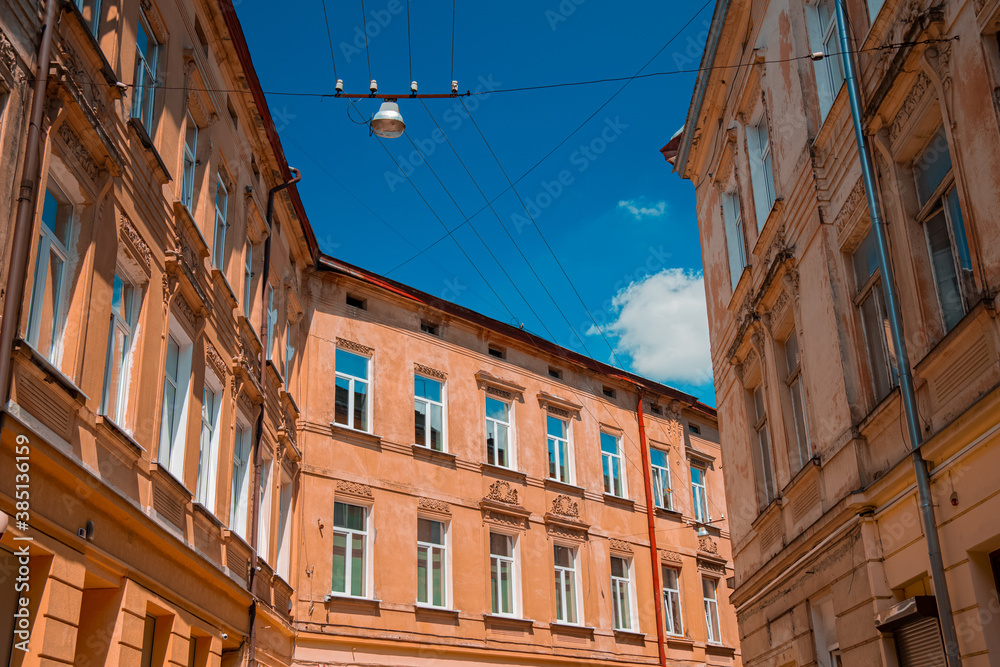 old city street building exterior facade side with rose walls and ...
