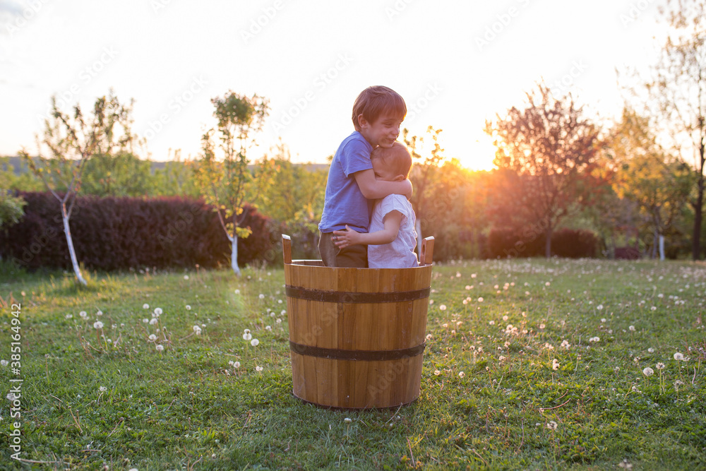Kids playing in barrel Stock Photo | Adobe Stock