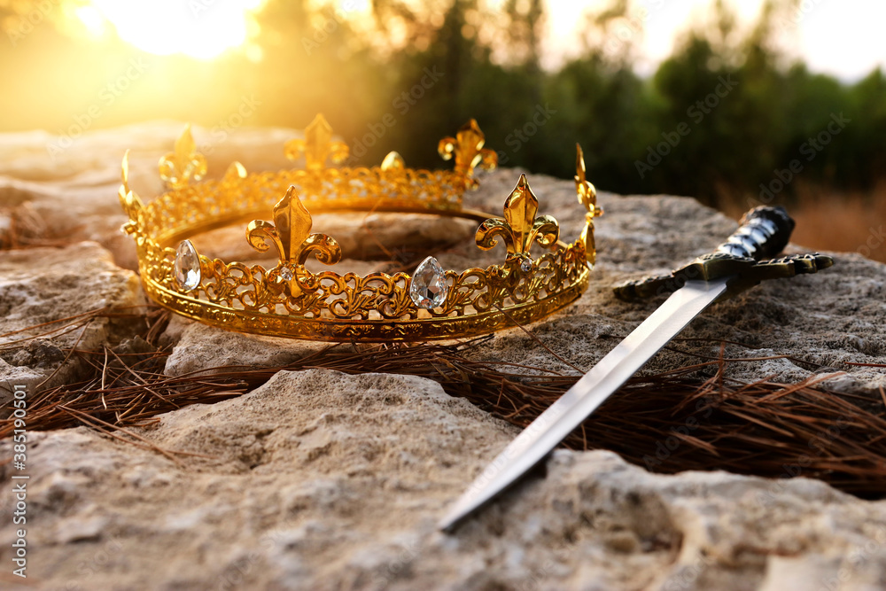 mysterious and magical photo of gold king crown and sword in the ...