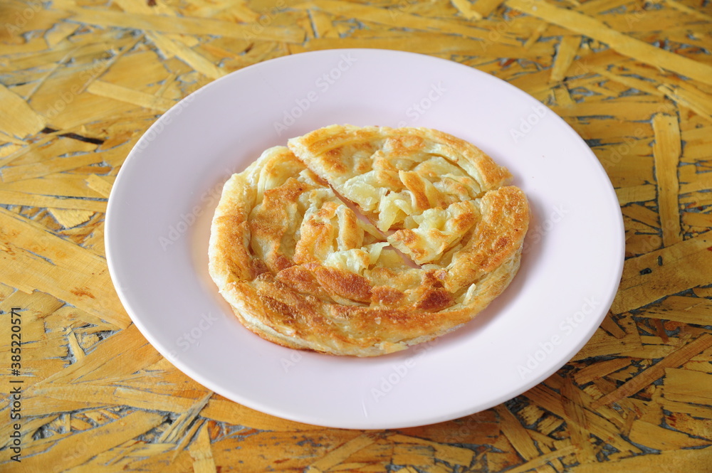 Roti and sweetened condensed milk on wooden table,Roti Canai or Roti ...