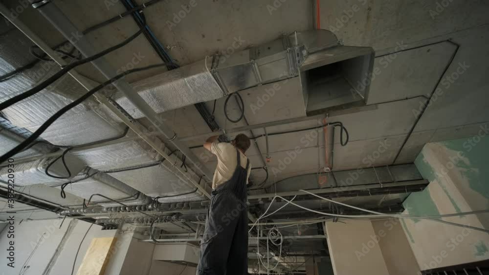 Installation of electrical wiring on the ceiling.Electrical cable ...