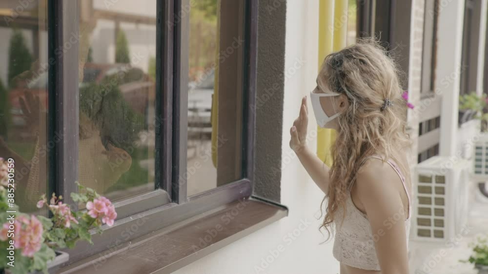 Two friends meet and talking through a window in face mask on safe ...