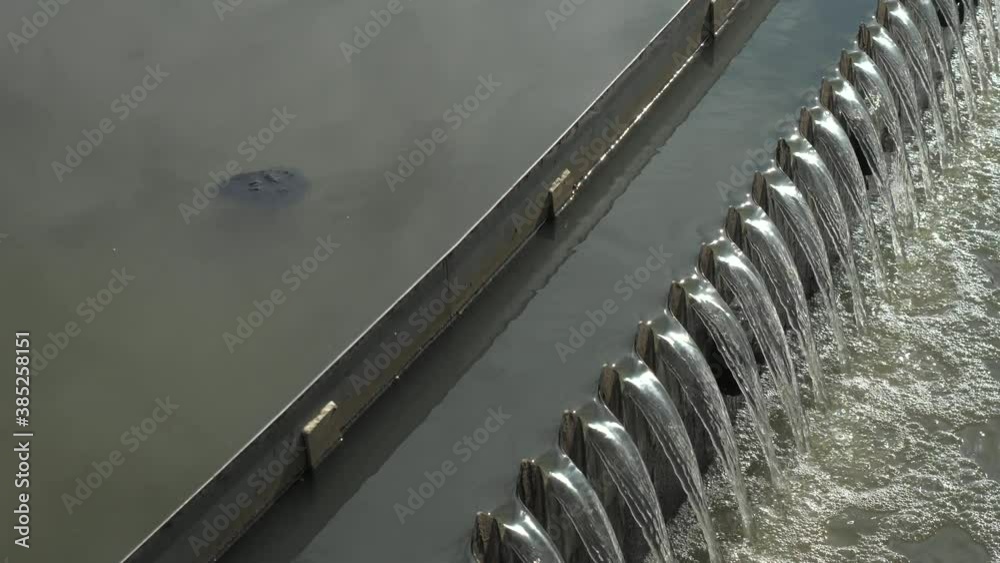 Rotting cellulose floats on the surface and stainless steel rake clean ...