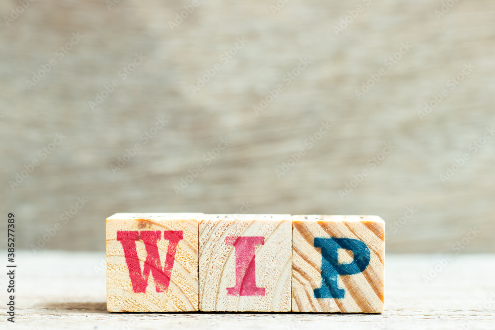 Alphabet letter in word WIP (Abbreviation of work in progress) on wood ...