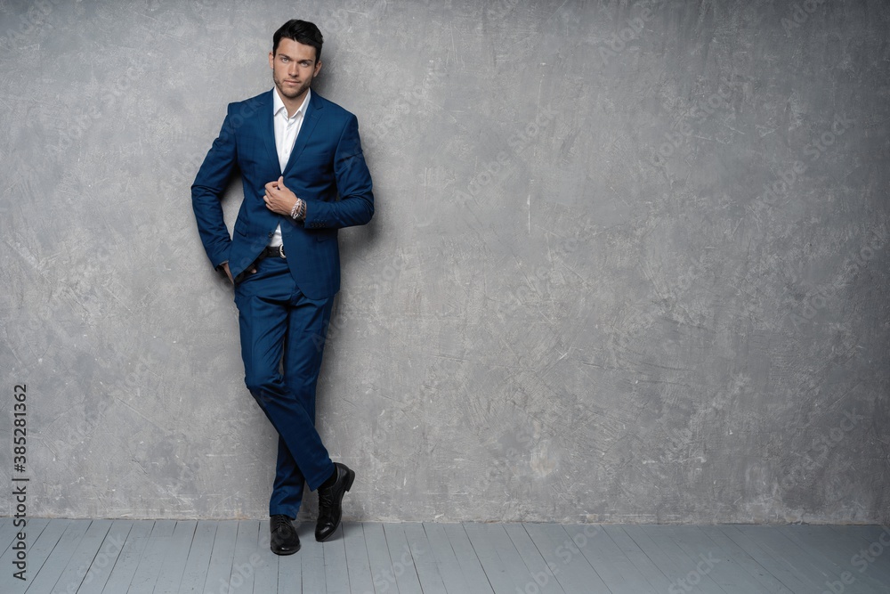 full length of handsome man wear blue suit isolated on grey background ...