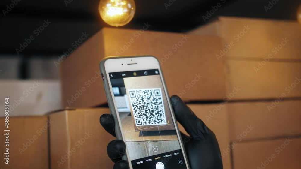 Asian man checking qr code by mobile phone on warehouse, big stock e ...