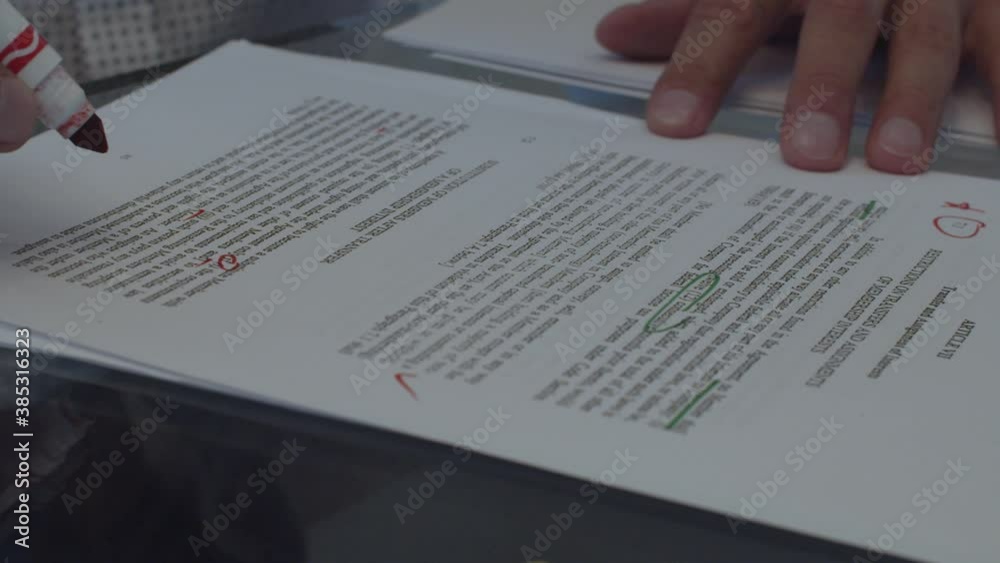 Male hands using a marker pen, highlighting and marking important text ...