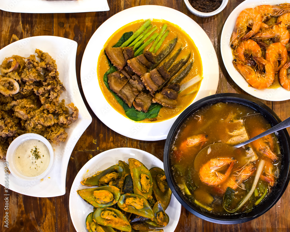 Top view of Filipino cuisine on a wood table at a local restaurant ...