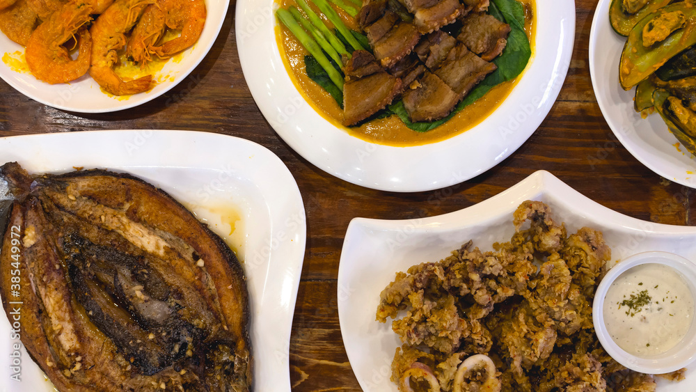 Cropped Top view of Filipino cuisine on a wood table at a local ...