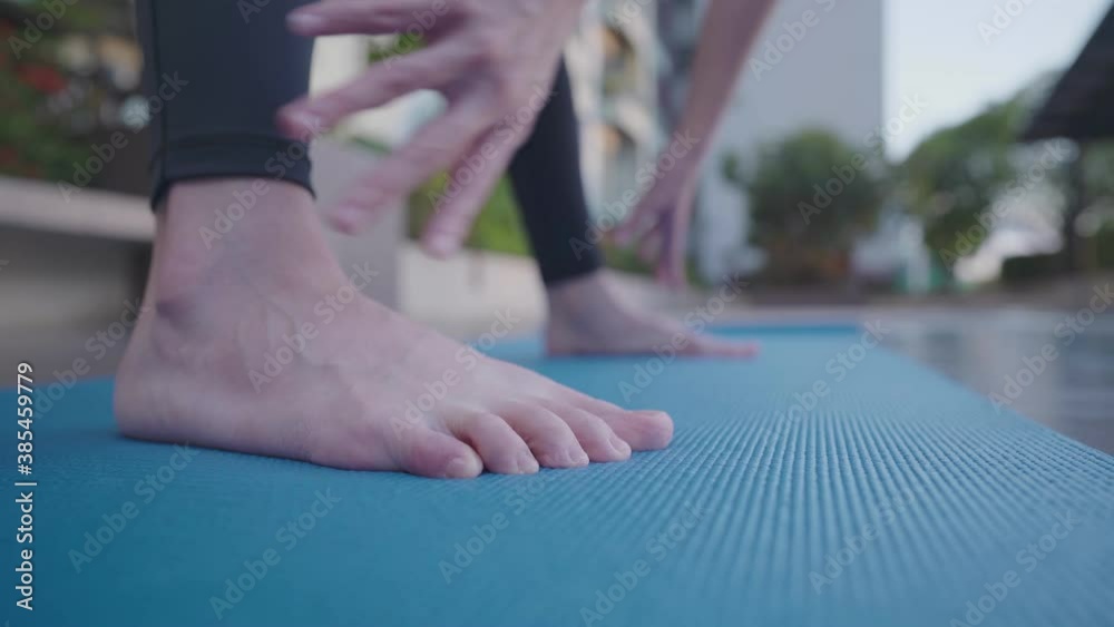 Close up female hand reaching foot practicing yoga pose bending down ...