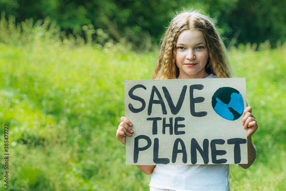 happy smiling child looking to camera holding a colorful save planet ...