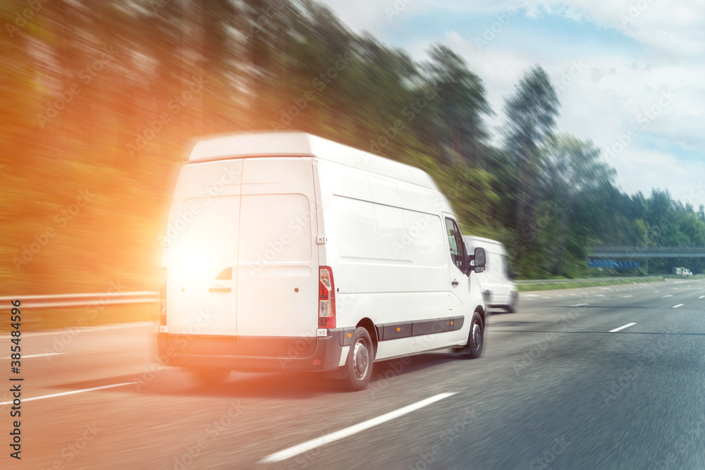 White modern delivery small shipment cargo courier van moving fast on ...