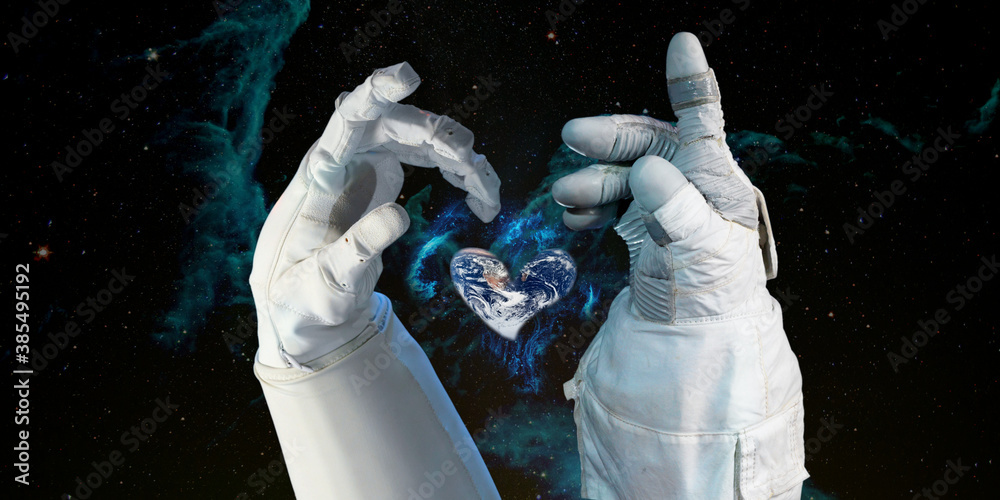 Earth heart in astronaut hands in space background, among stars and ...