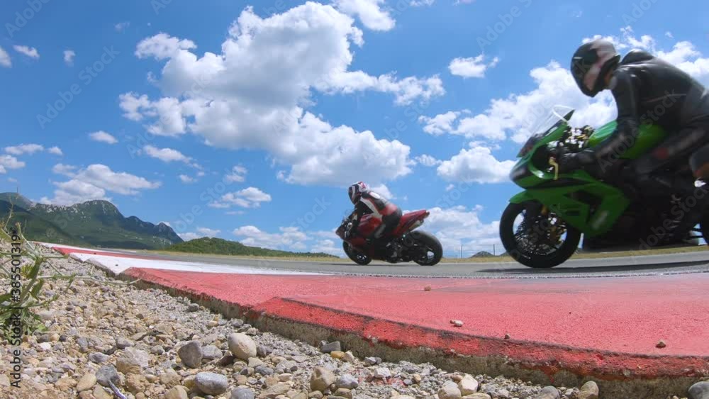 Steady shot of motor riders racing on the raceway. Group of riders ...